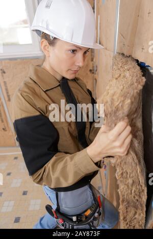 female worker at a indoors wall insulation works Stock Photo - Alamy