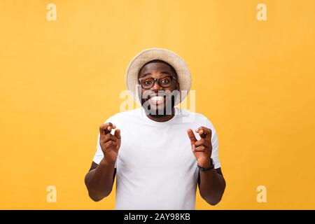 Hopeful young man cross fingers, wishing, praying and anticipating good ...