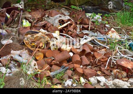 Wild garbage dump in nature. Open landfill site. Pile of garbage ...