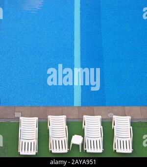 A view of a poolside and sunbeds Stock Photo - Alamy
