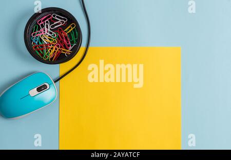 Cardboard and writing equipment with modern gadget above pastel ...