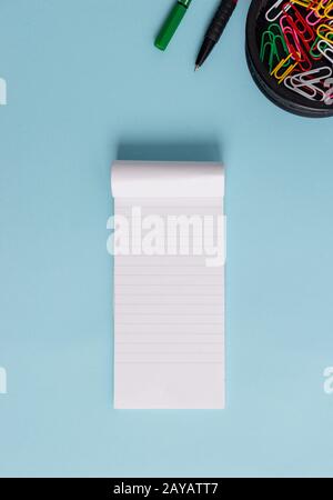 Notebook and writing equipment with computer tool above pastel backdrop ...