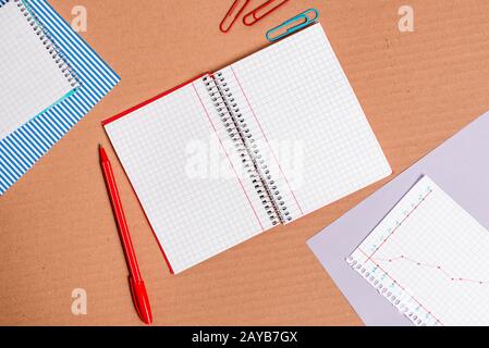 Cardboard desk with a striped blue sheet, notebook paper and office ...