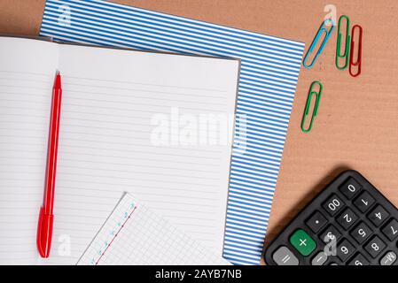 Cardboard desk with a striped blue sheet, notebook paper and office ...