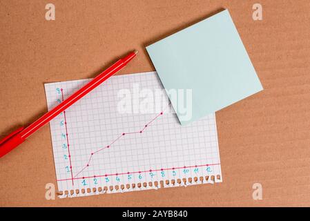Cardboard desk with notebook paper and office appliances. Paperboard ...