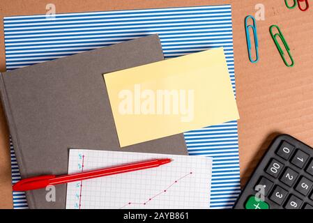 Cardboard desk with a striped blue sheet, notebook paper and office ...