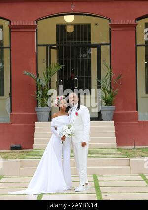 PORT OF SPAIN, TRINIDAD - FEB 14: Renee Butcher is escorted by her ...