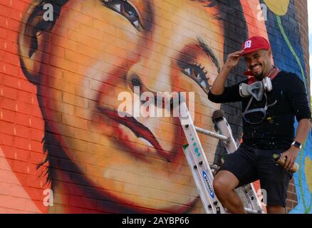 Artist Armando Silva while working on a mural at the Boulder Chamber of ...