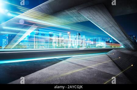 light trails and cityscape with empty road floor Stock Photo - Alamy