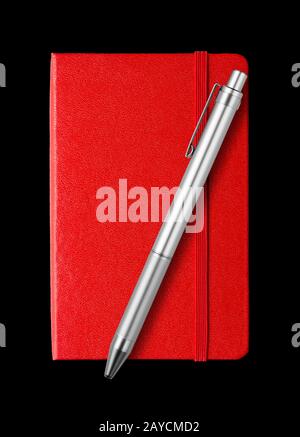 Black closed notebook with a pen. Mockup isolated on wooden background ...