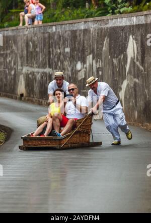 FUNCHAL, MADEIRA - SEPTEMBER 19: Traditional downhill sledge trip on ...