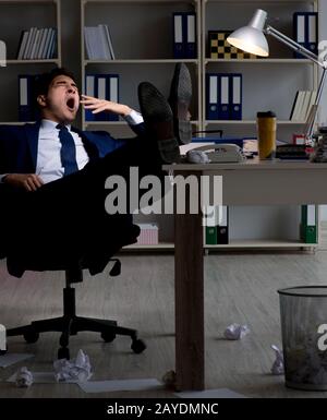 Employee working late to finish important deliverable task Stock Photo ...