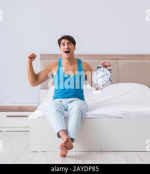 young angry man waking up Stock Photo - Alamy
