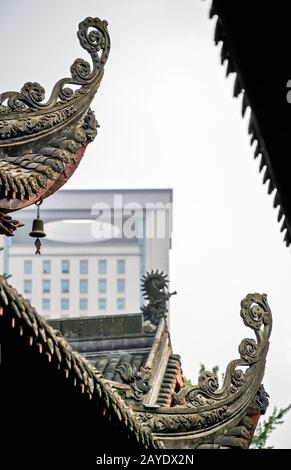 Traditional Chinese wooden architecture with curved roof eaves and ...