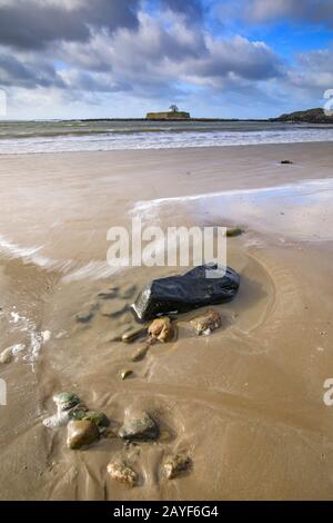 St Cwyfan’s Church on the island of Cribinau backed by the Lleyn ...