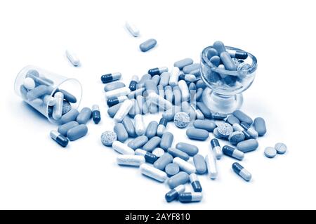 Shot of blue drugs (tablets) on light background Stock Photo - Alamy