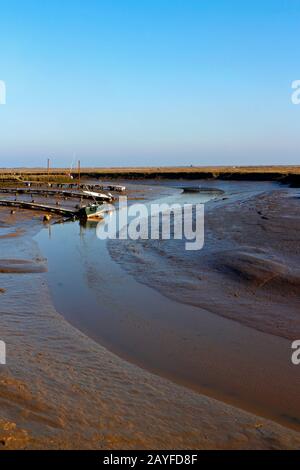 A view of the tidal channel through salt marshes towards the sea at ebb ...