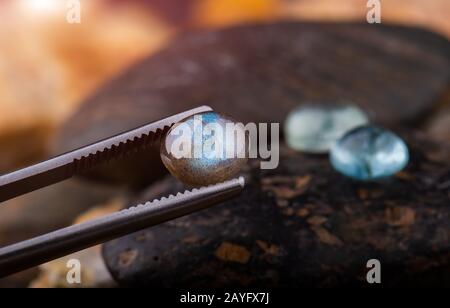 Round cut labradorite mineral gemstones with dark stones background ...