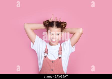 Funny teenager child girl show peace cool v-sign isolated over yellow ...