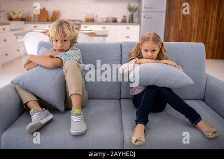 Sister is sitting offended Stock Photo - Alamy