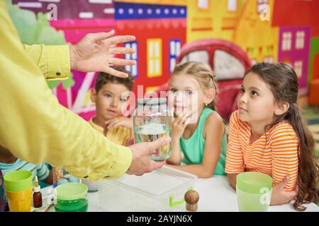 Cute kids watching science experiment with water Stock Photo - Alamy