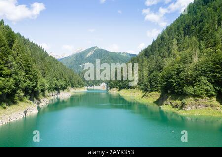 Val Noana artificial lake, Mezzano, Italy. Mountain landscape. Green ...