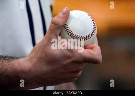 A pitcher shows off baseball grips for throwing Stock Photo - Alamy
