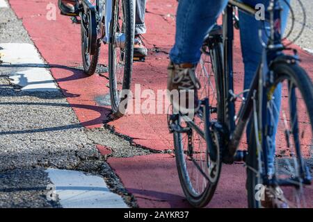Cyclists use cycle path in poor condition Stock Photo - Alamy