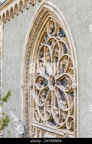 Pigeons resting on the gothic window of a historic church or cathedral ...