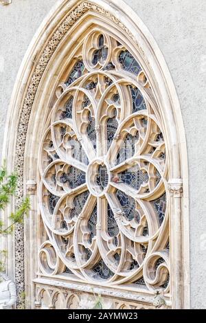 Pigeons resting on the gothic window of a historic church or cathedral ...
