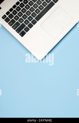 Front view of an open blue laptop, a white coffee mug and a blank ...