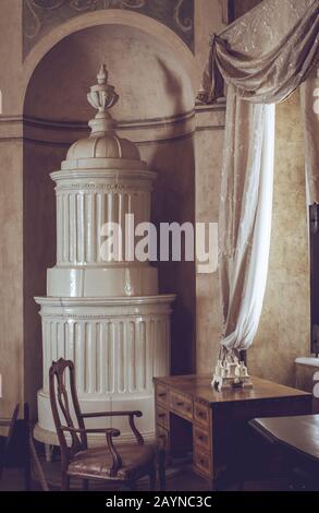 European old stove covered with ceramic majolica. ceramic wood burning ...