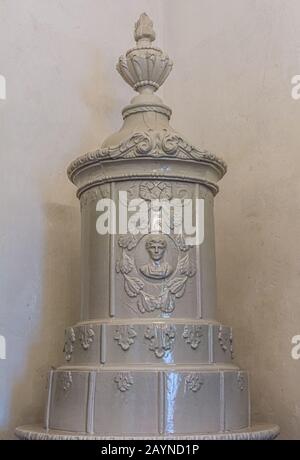 European old stove covered with ceramic majolica. ceramic wood burning ...