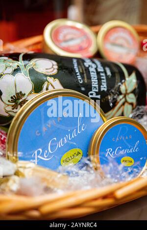 Basket with Christmas gift boxes, champagne, oranges and decor Stock ...