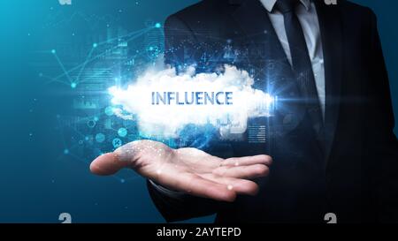 Hand of Businessman holding INFLUENCE inscription, successful business ...