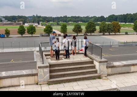 Group of people standing on Adolf Hitlers podium in the main grandstand ...
