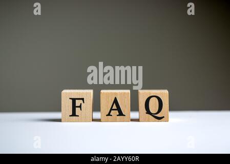 FAQS symbol. Wood cubes with word 'FAQS - frequently asked questions ...