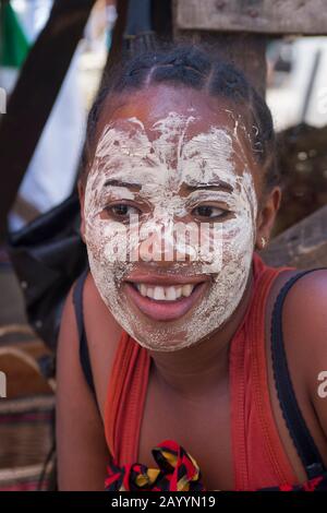 Malagasy woman. On her face is a paste made from the sandalwood shrub ...