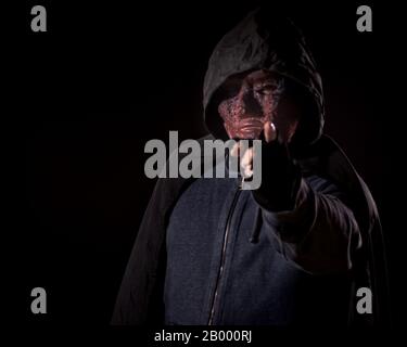 Person in costume of ghost pointing at something on yellow background ...