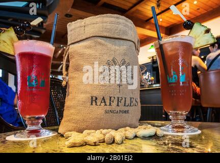 Inside the famous Raffles Long Bar, Singapore showing a traditional bag ...