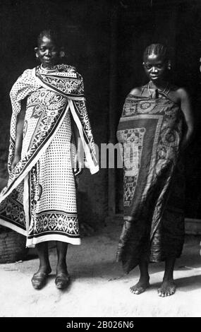 Swahili women in traditional dresses walking on the beach in Stone Town ...