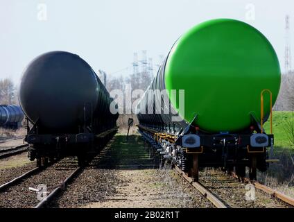 green bio fuel freight trains in railroad station with industrial ...
