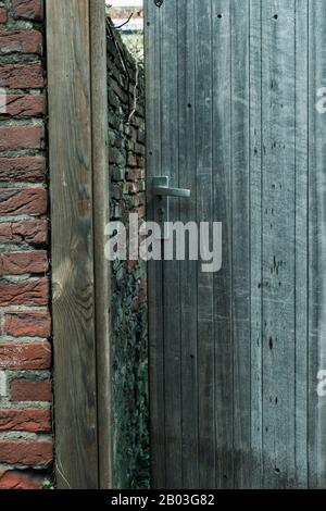 Weathered wooden garden door ajar Stock Photo - Alamy