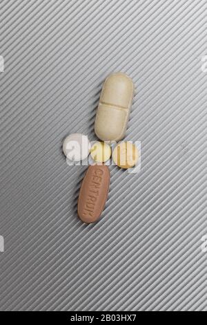 A daily ration of pills for an senior citizen. A vitamin, glucosamine ...