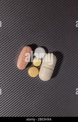 A daily ration of pills for an senior citizen. A vitamin, glucosamine ...