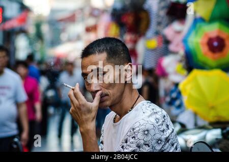Chinese smoker / man smoking / smokes a cigarette in Sichuan Stock ...