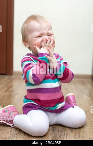 Angry toddler baby girl in room Stock Photo - Alamy