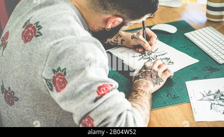 Tattoo artist drawing Stock Photo - Alamy