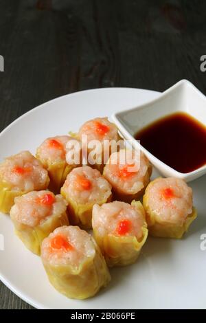 A closeup of delicious Chinese shumai dumplings on a xiaolong bamboo ...