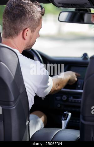 a man touching the car dashboard Stock Photo - Alamy